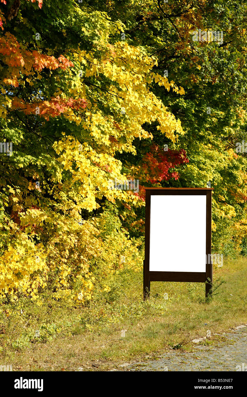 billboard next to autumnly colored trees Stock Photo - Alamy