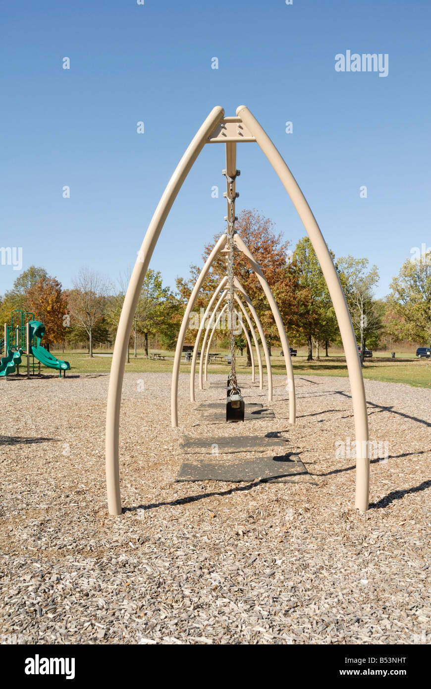 empty swing set on playground in fall Stock Photo - Alamy