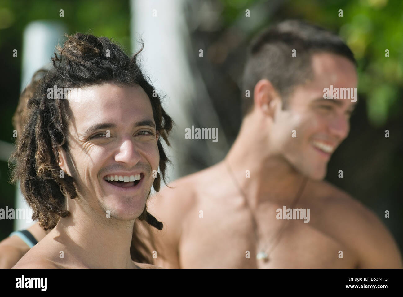 Hispanic man laughing with friends Stock Photo - Alamy