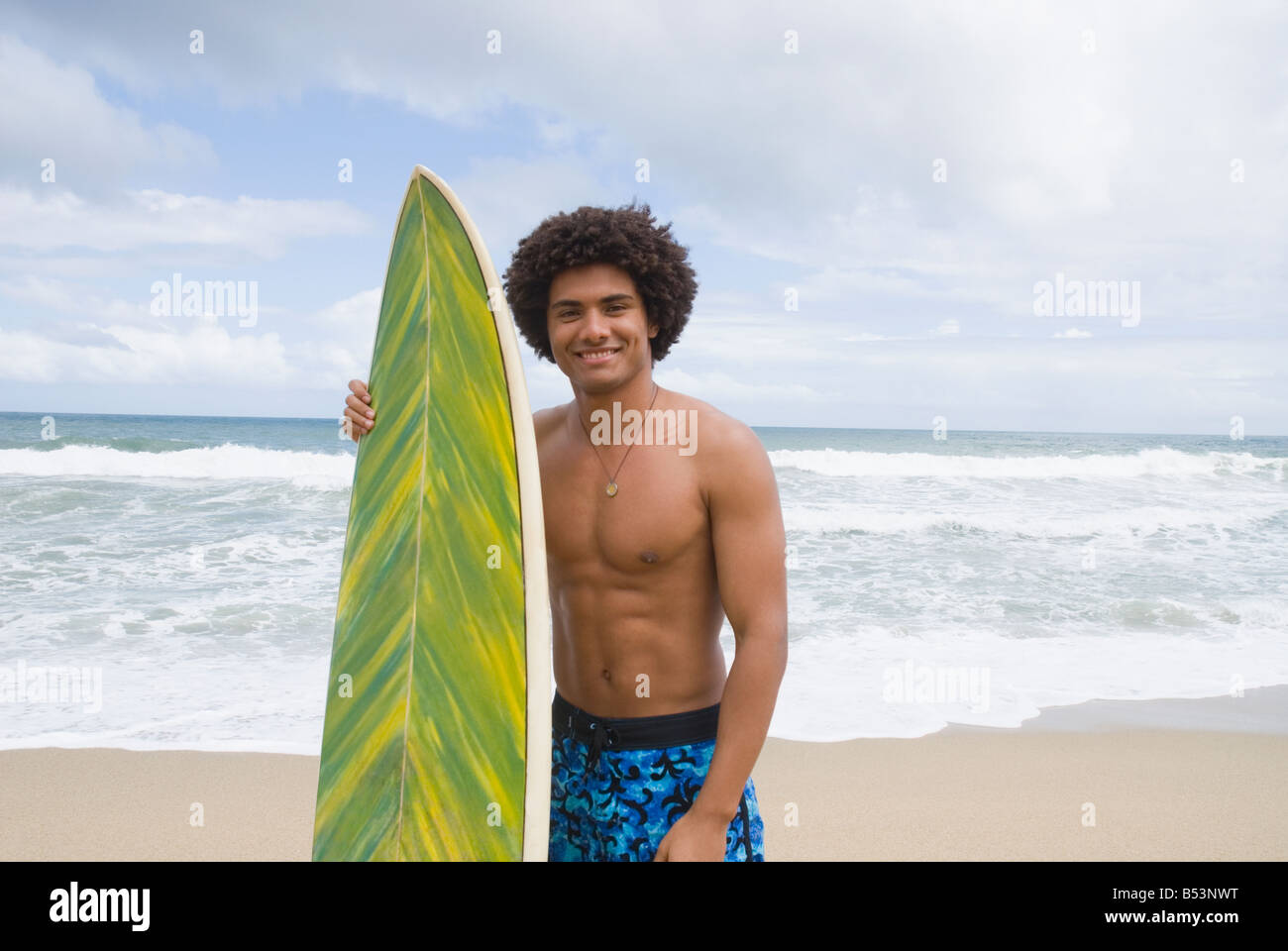 African man at beach with surfboard Stock Photo - Alamy