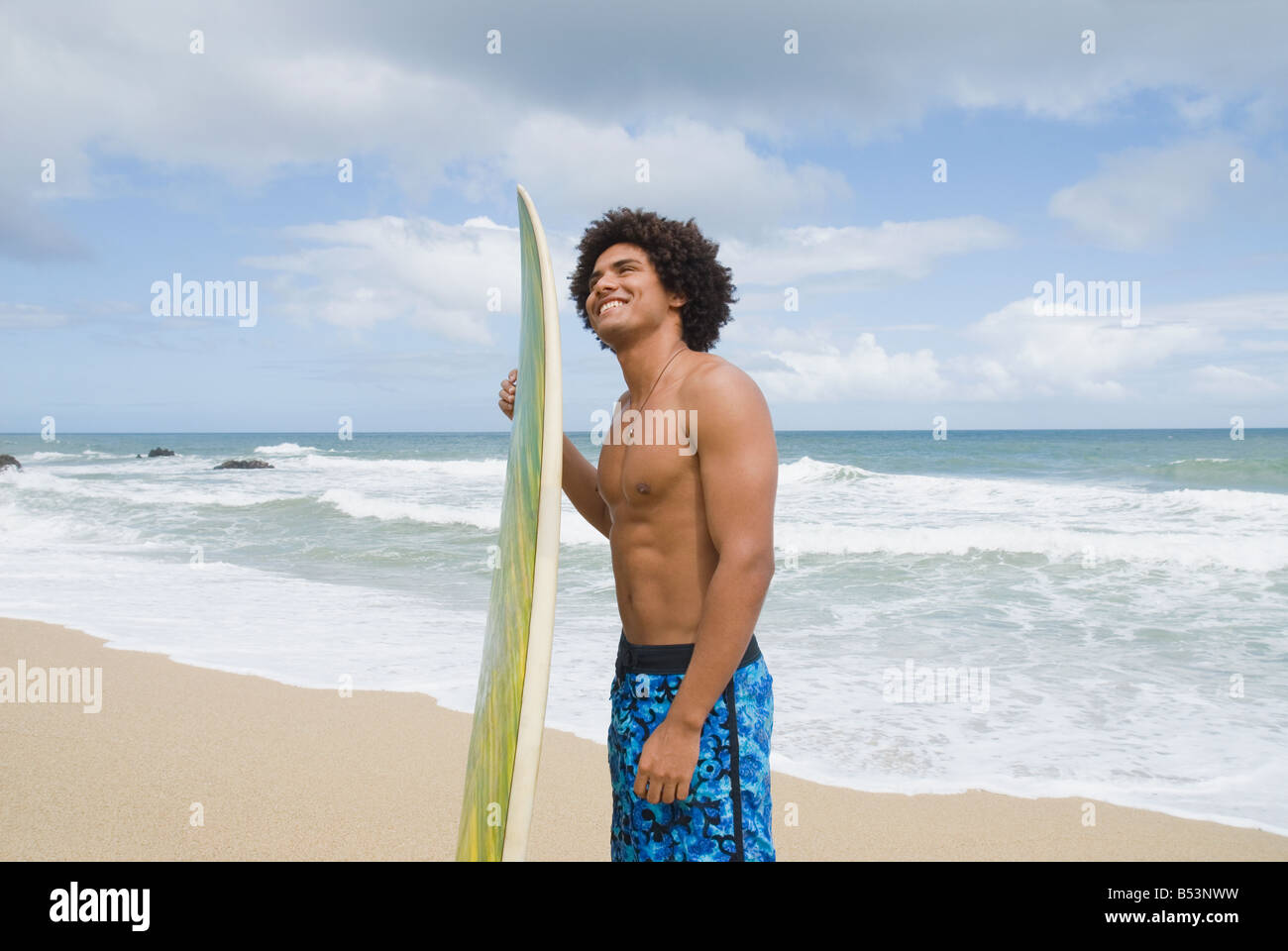 African man at beach with surfboard Stock Photo - Alamy