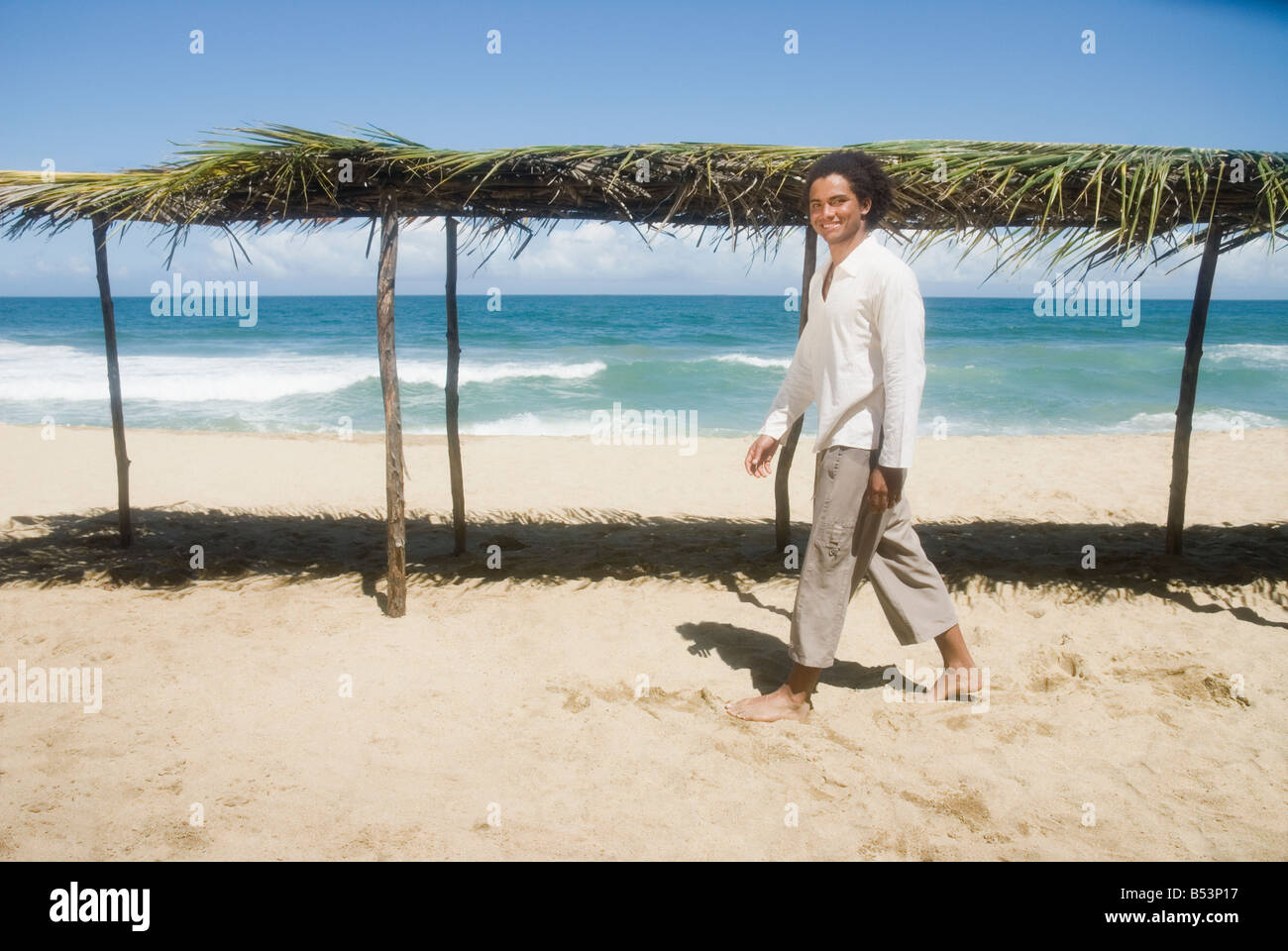 African man walking at beach Stock Photo - Alamy