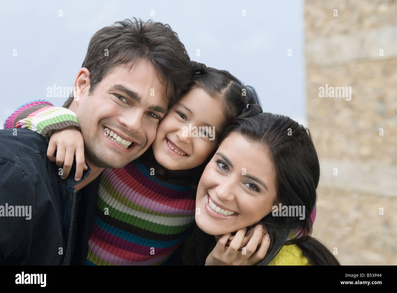 Happy Hispanic family hugging Stock Photo - Alamy