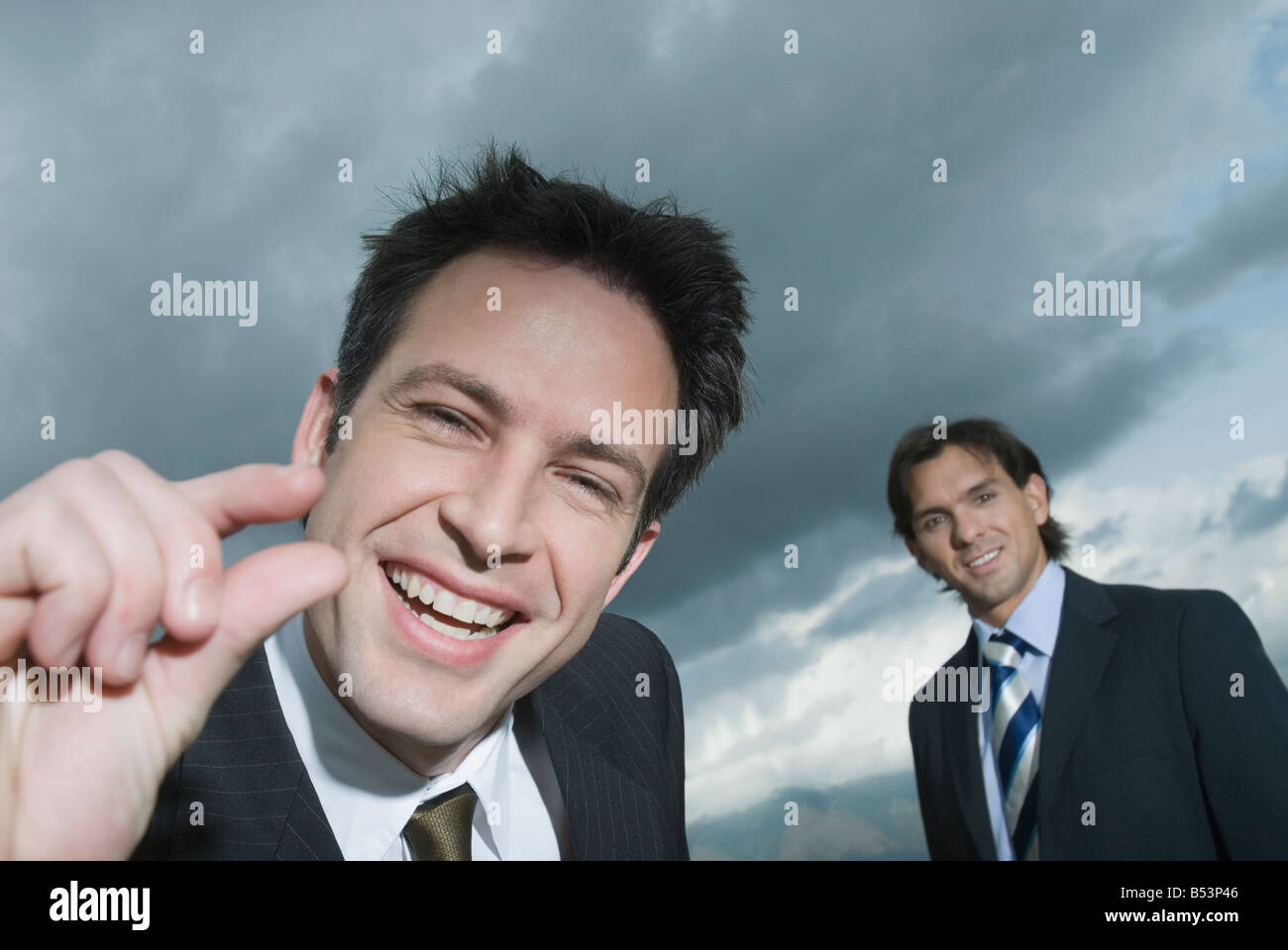 Hispanic businessman making pinching motion Stock Photo - Alamy