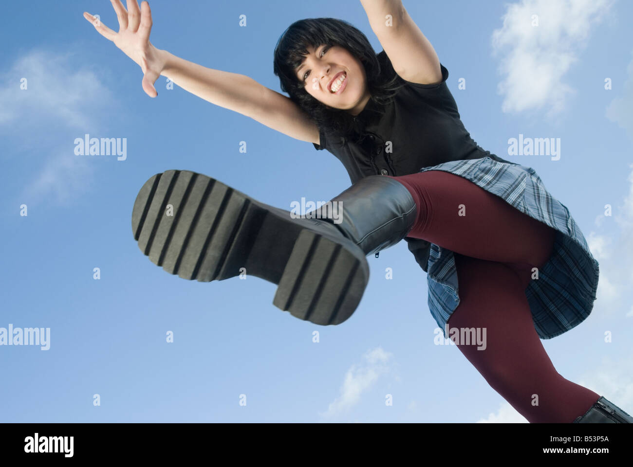 Angry Hispanic woman jumping Stock Photo - Alamy