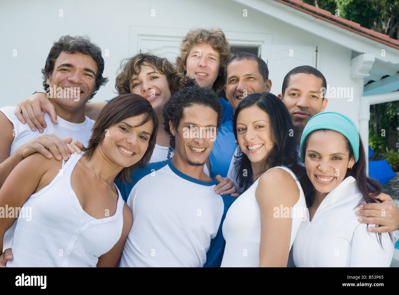 Multi-ethnic friends hugging Stock Photo - Alamy