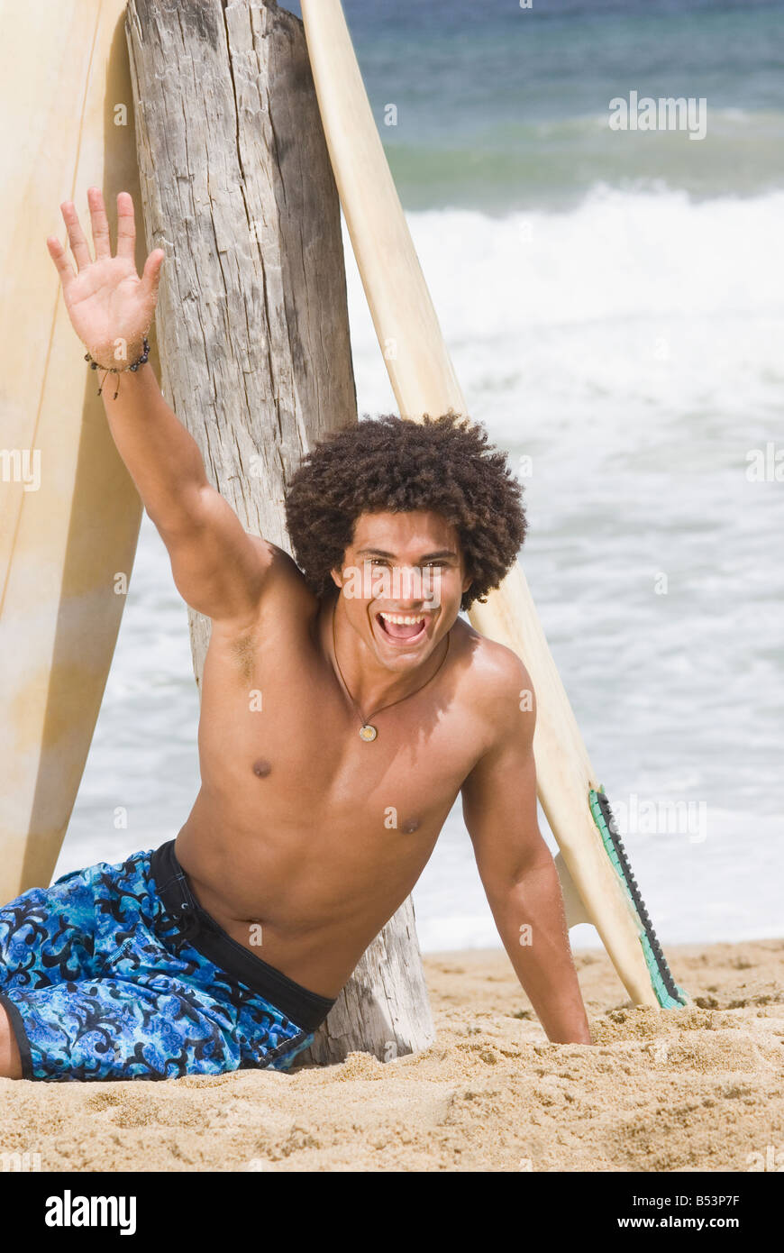 African man at beach with surfboard Stock Photo - Alamy