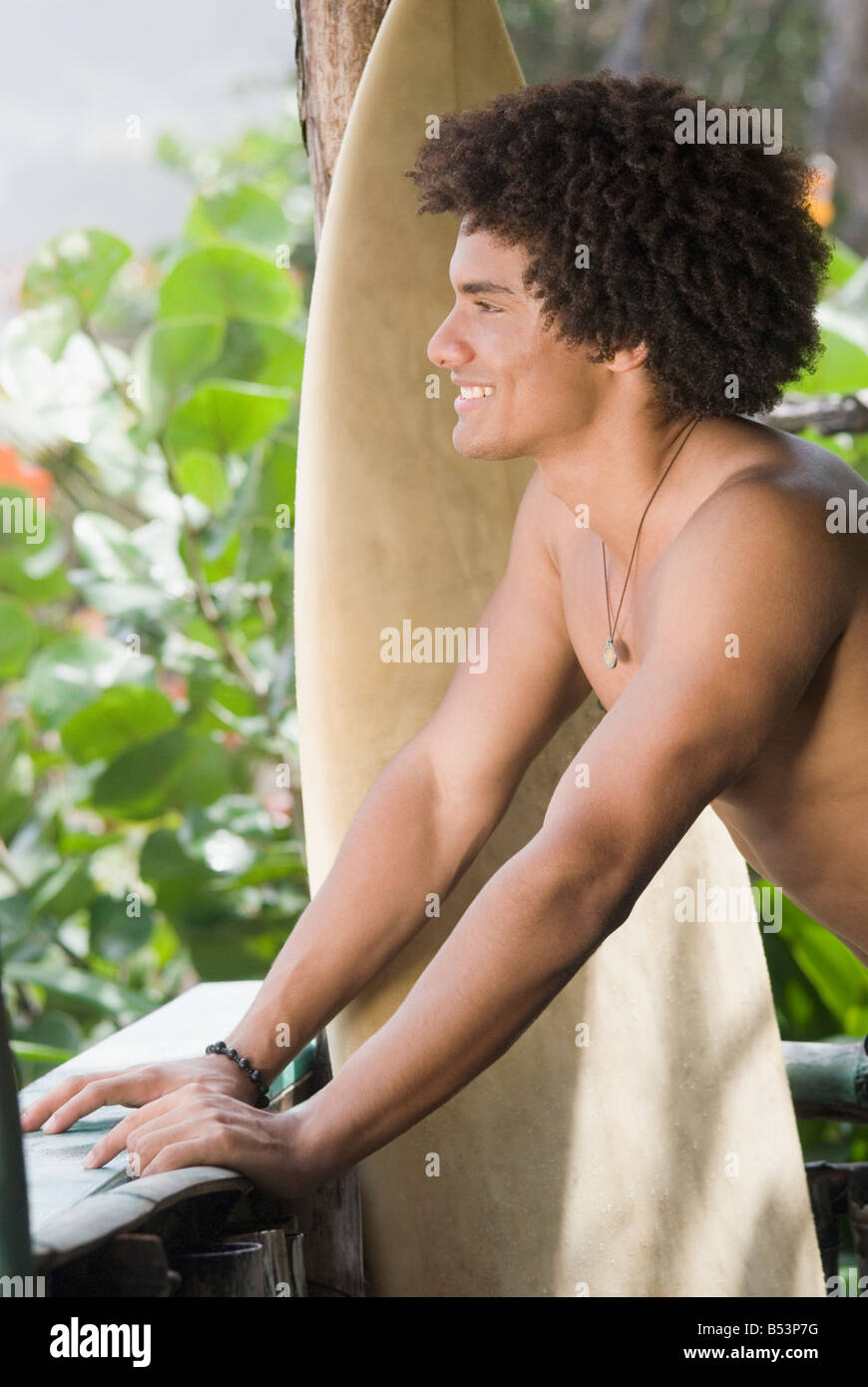 African man at beach with surfboard Stock Photo - Alamy