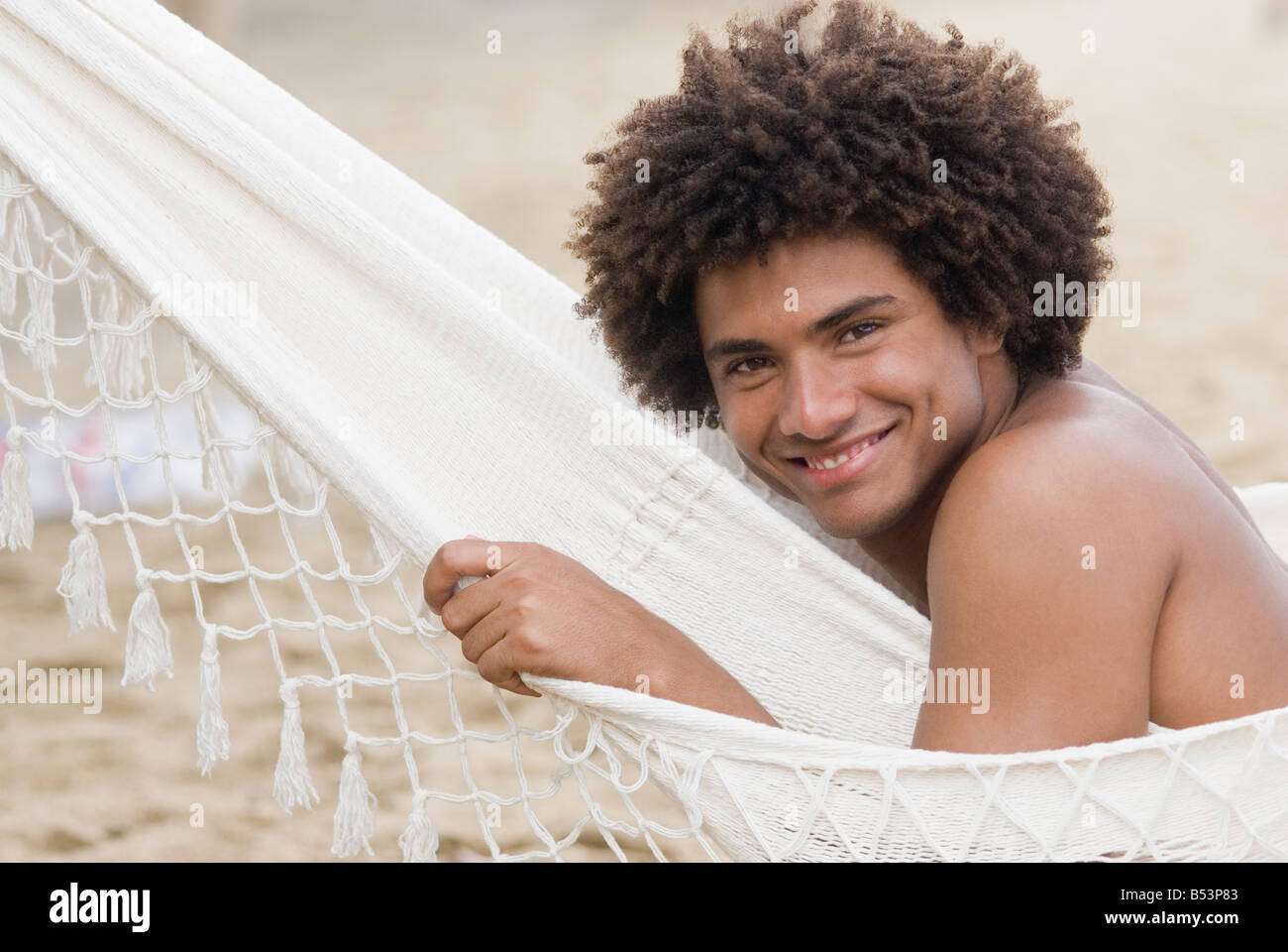 African man laying in hammock Stock Photo - Alamy