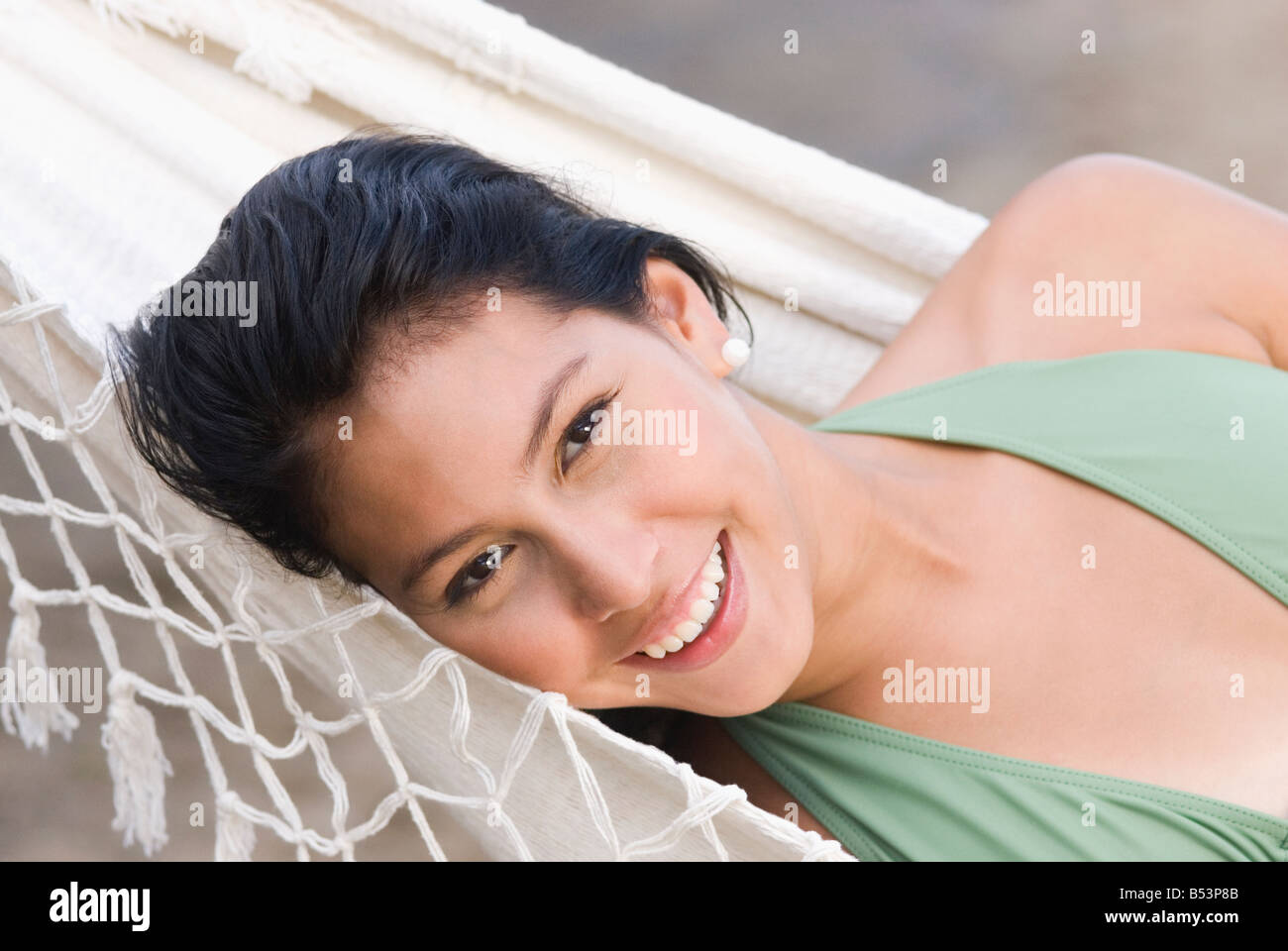 Hispanic woman laying in hammock Stock Photo - Alamy