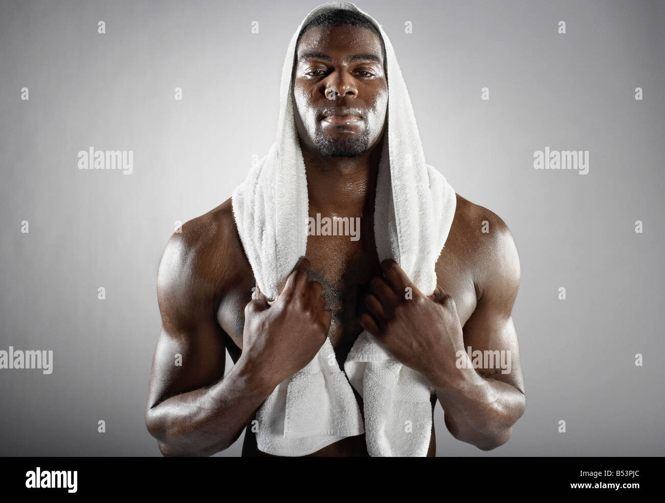 Sweating African man with towel Stock Photo - Alamy