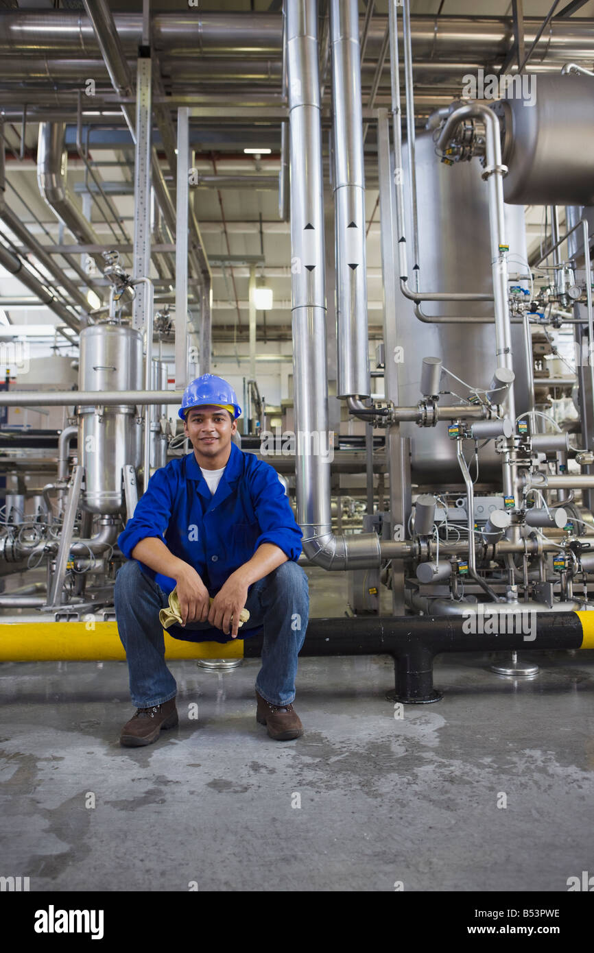African worker sitting in factory Stock Photo - Alamy