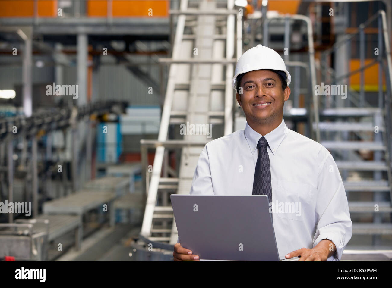 African manager with laptop in factory Stock Photo - Alamy