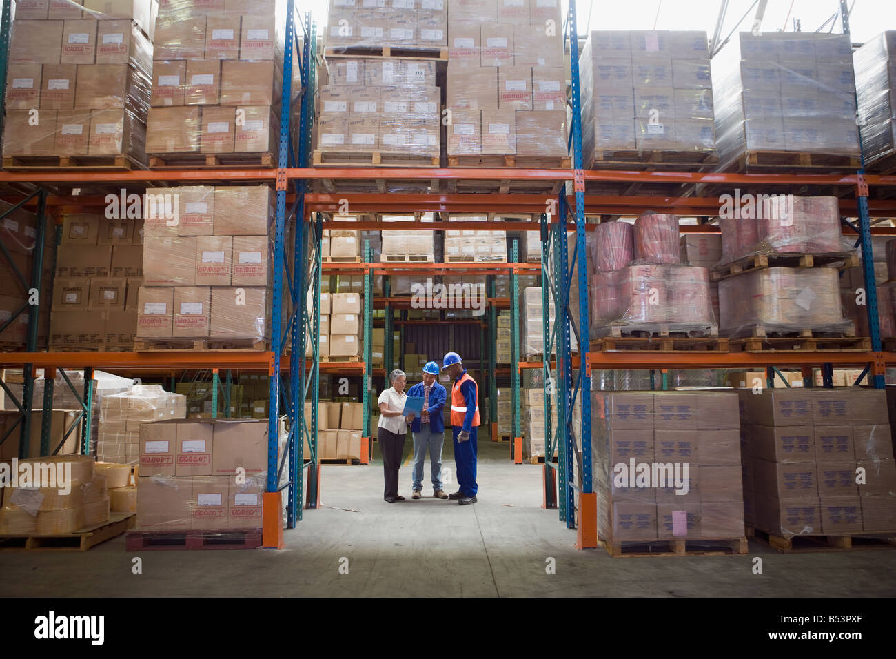 Workers talking in warehouse Stock Photo - Alamy