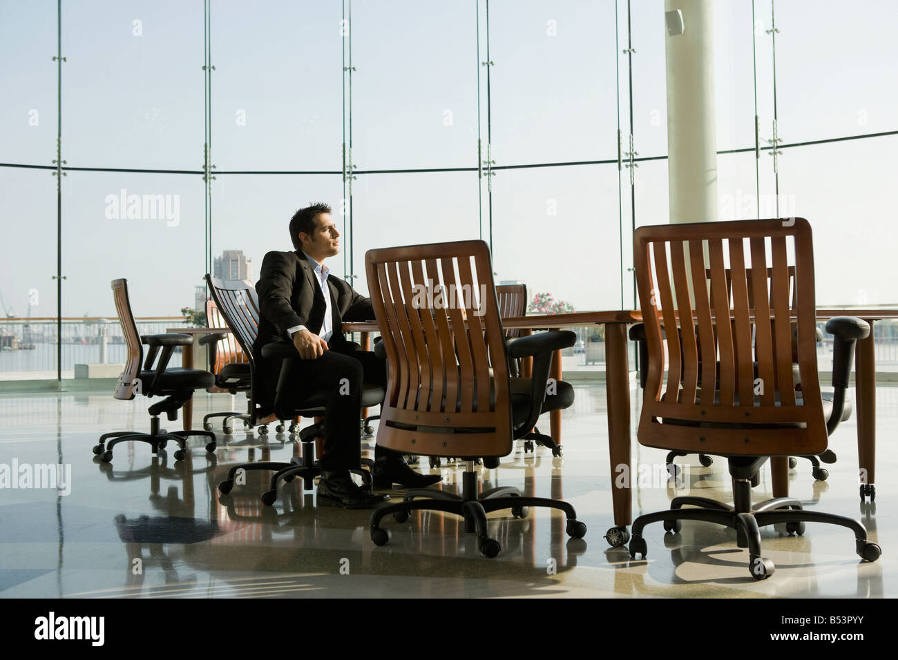 Businessman waiting in conference room for meeting Stock Photo - Alamy