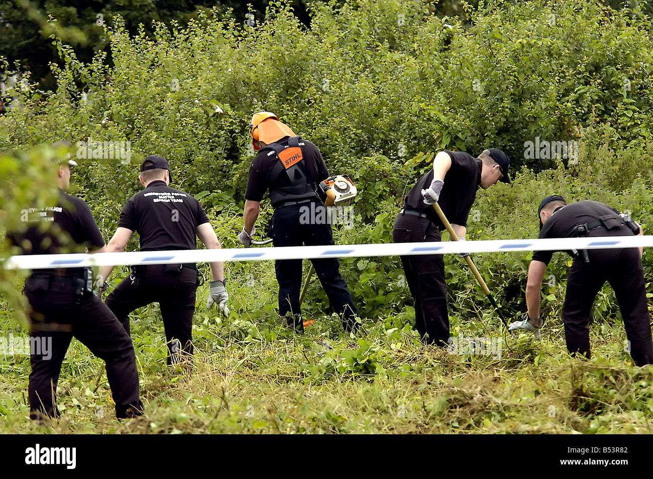Police Search Teams Hunt For Clues In Woodland At The Back Of The Fir