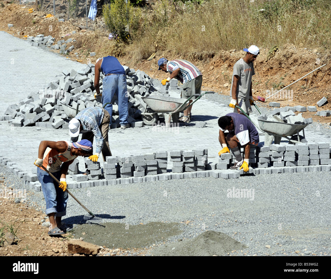 Turkish gang of men bulding block paving road Akyaka Turkey Stock Photo ...