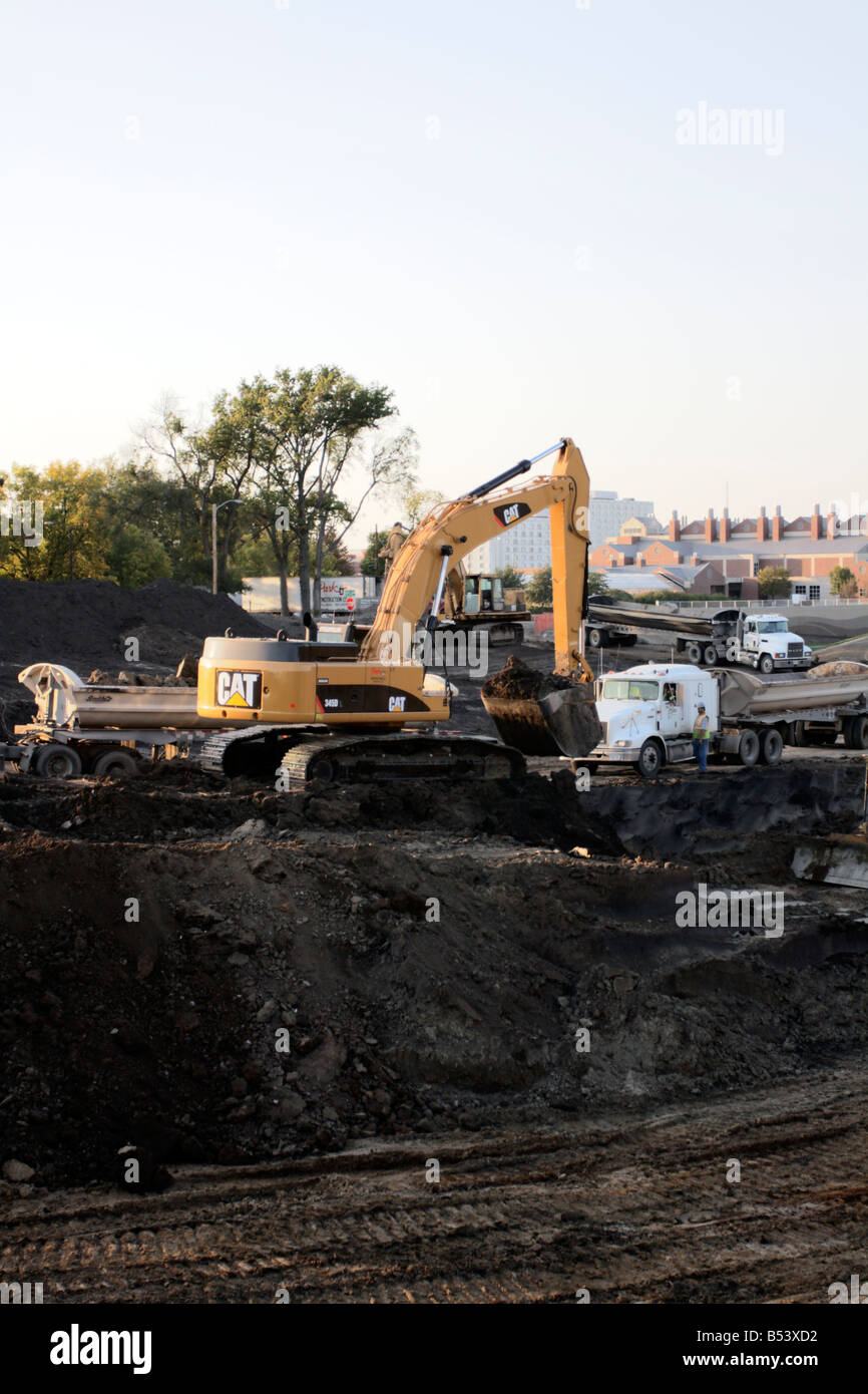 CAT bucket loader excavator, excavating drainage ditch Stock Photo - Alamy
