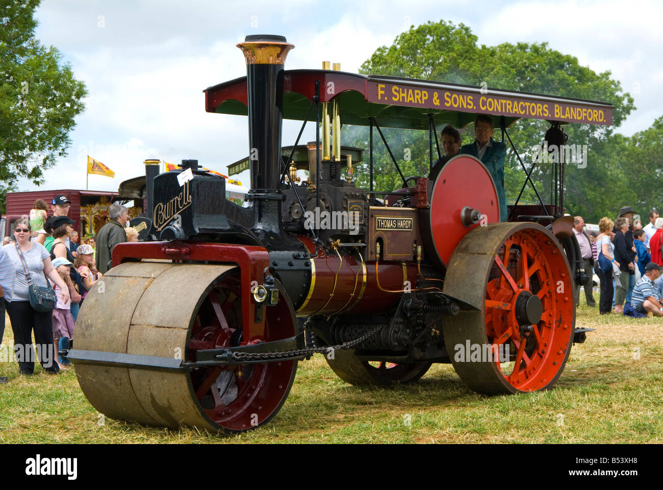 A crimson red Burrell steam road roller on its way to the parade ring ...