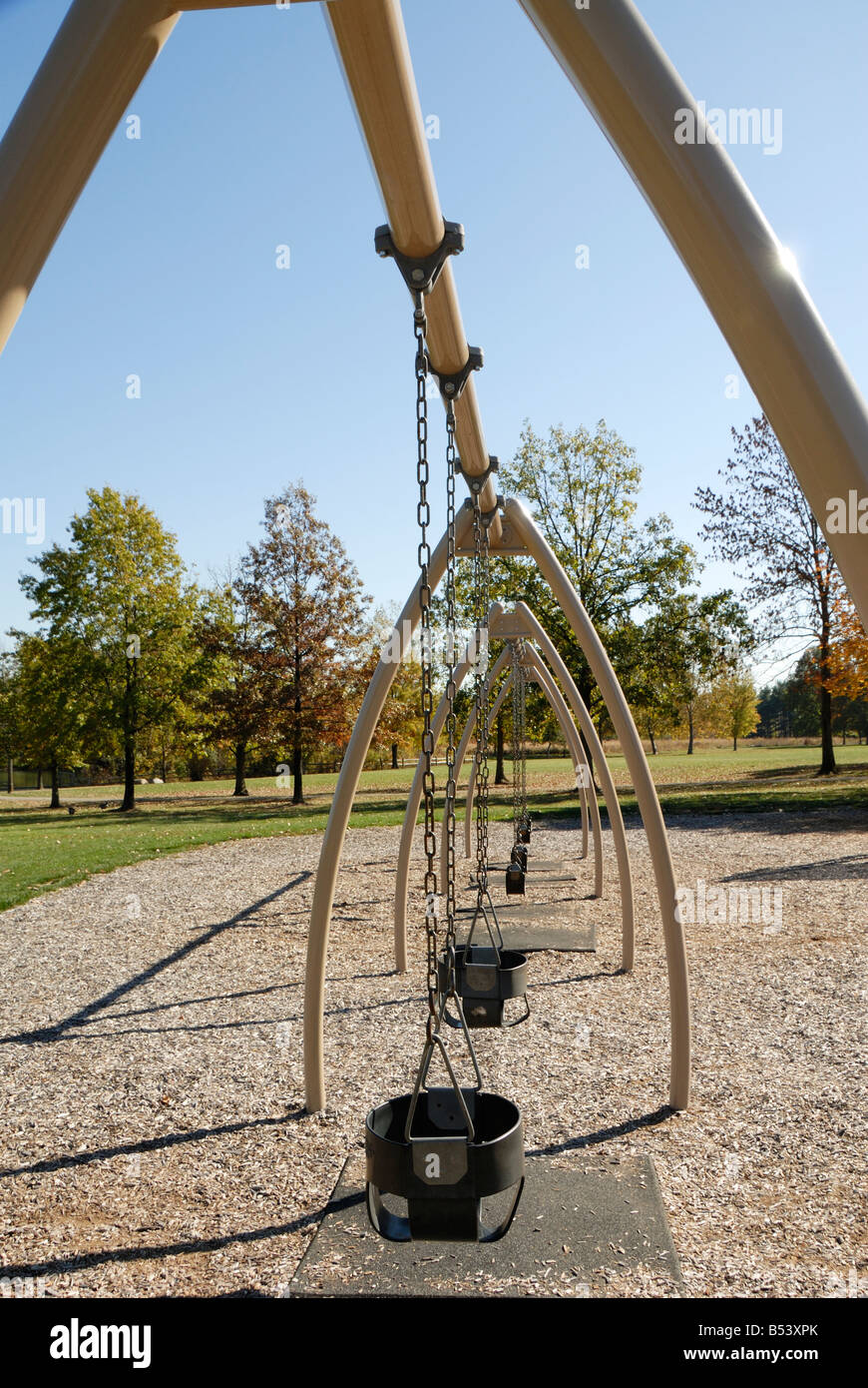 empty swing set on playground in fall Stock Photo - Alamy