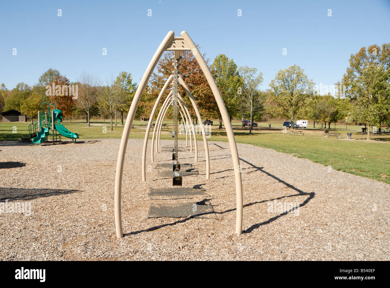 empty swing set on playground in fall Stock Photo - Alamy