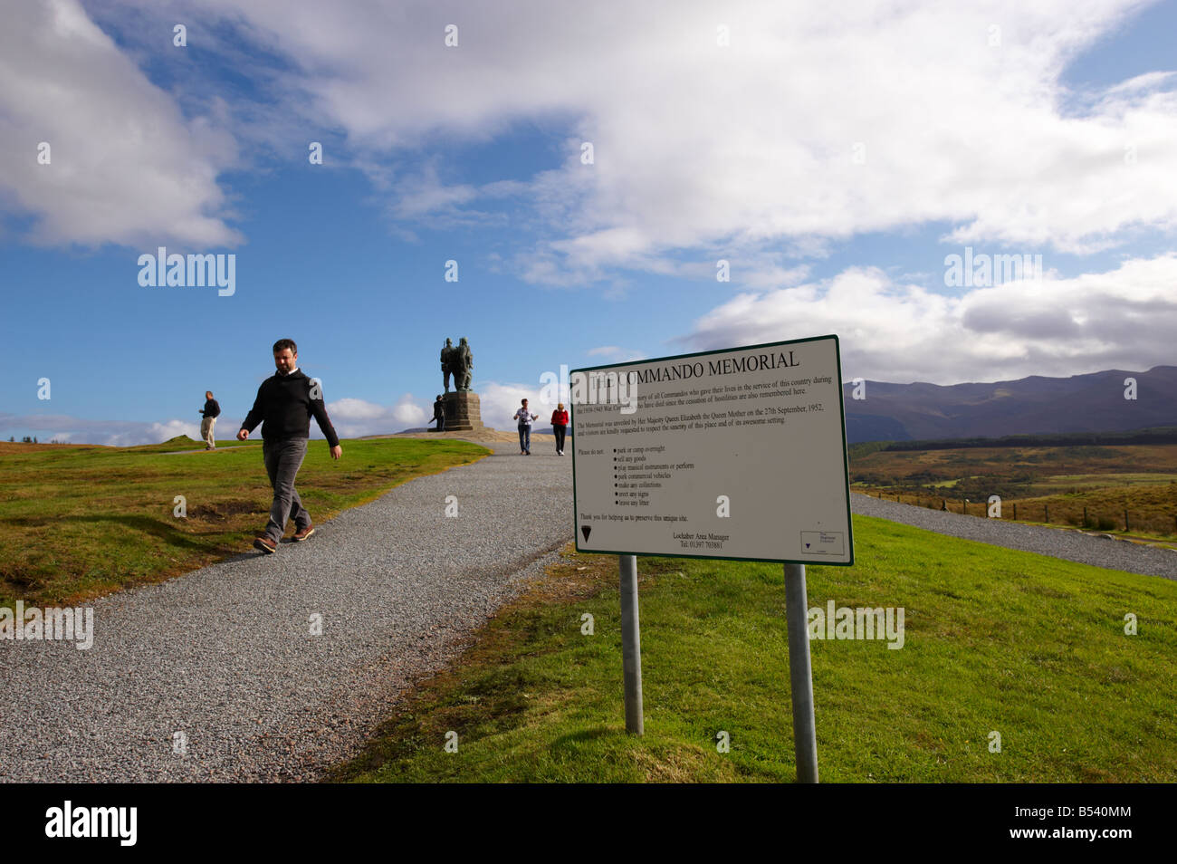 The Commando Memorial Visitors walking past sign to WW2 War Memorial ...