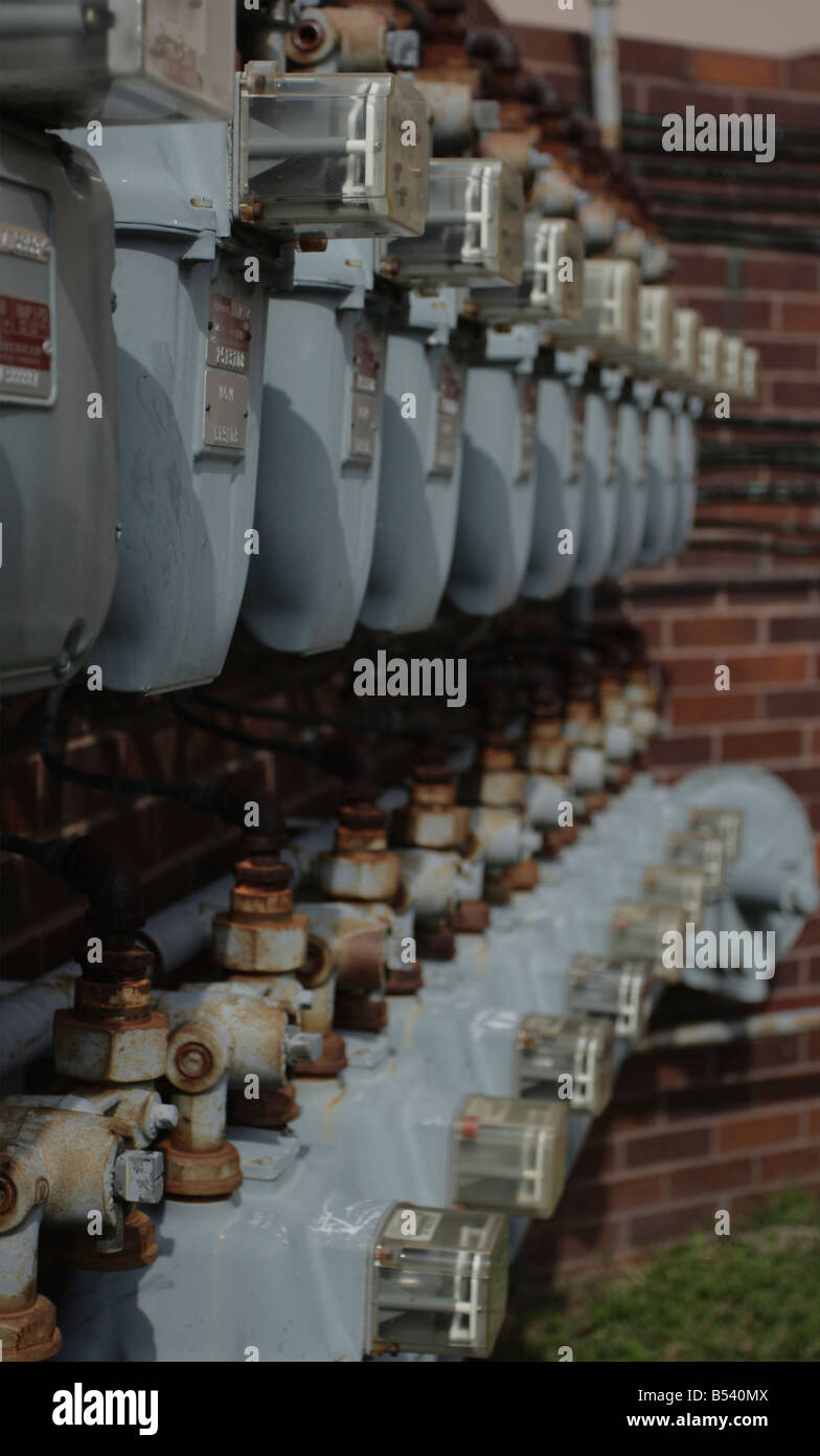 Row of natural gas meters with rusty fittings on brick wall Stock Photo ...