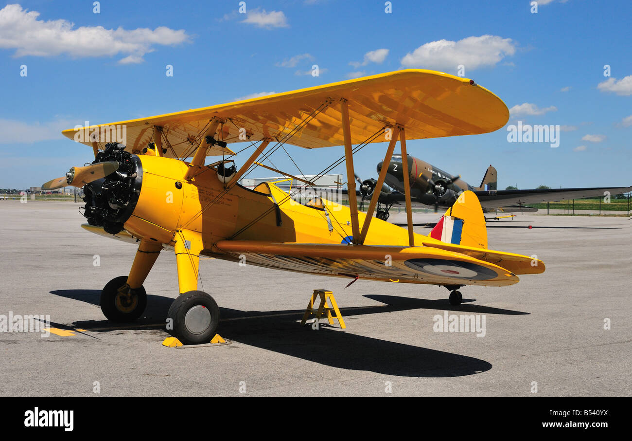 Yellow Biplane with Old Transport Plane Behind Stock Photo - Alamy