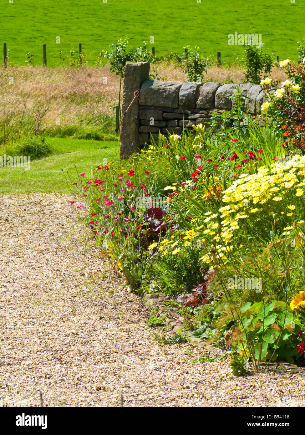 gravel path and gateway in a farm garden Stock Photo - Alamy