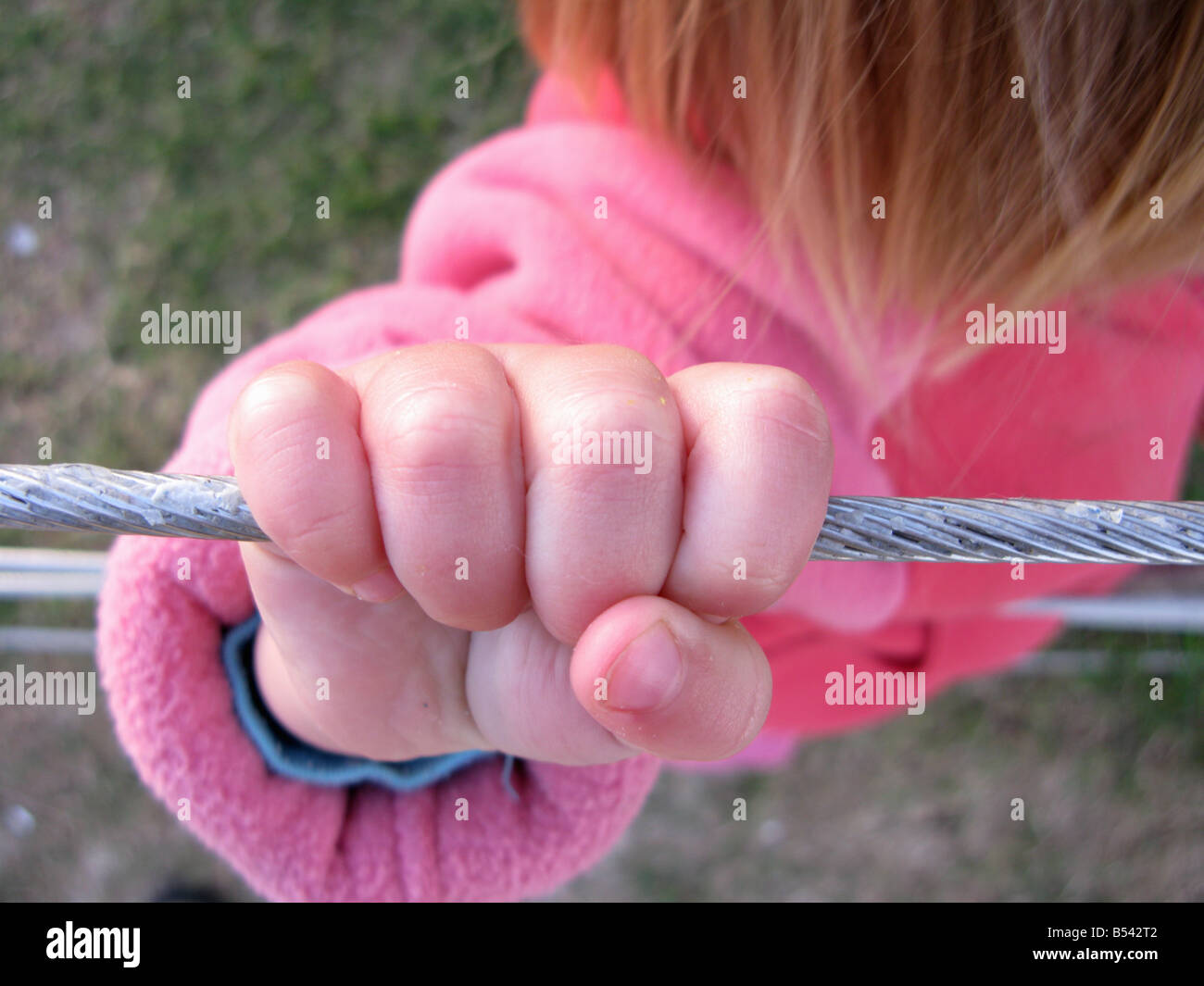 Close up of child s hand holding wire Stock Photo - Alamy