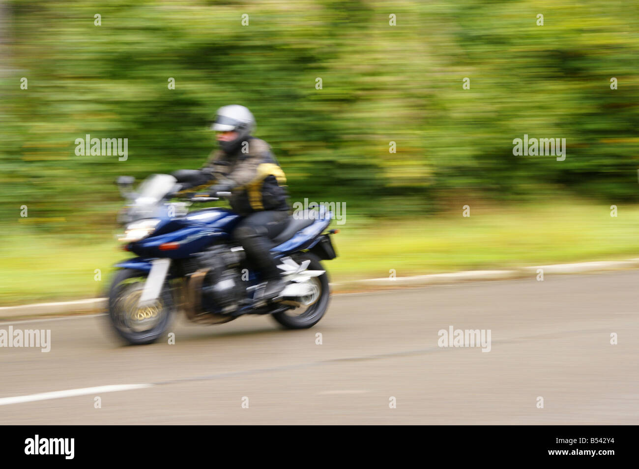 speed - danger - blurred motorcyclist Stock Photo - Alamy