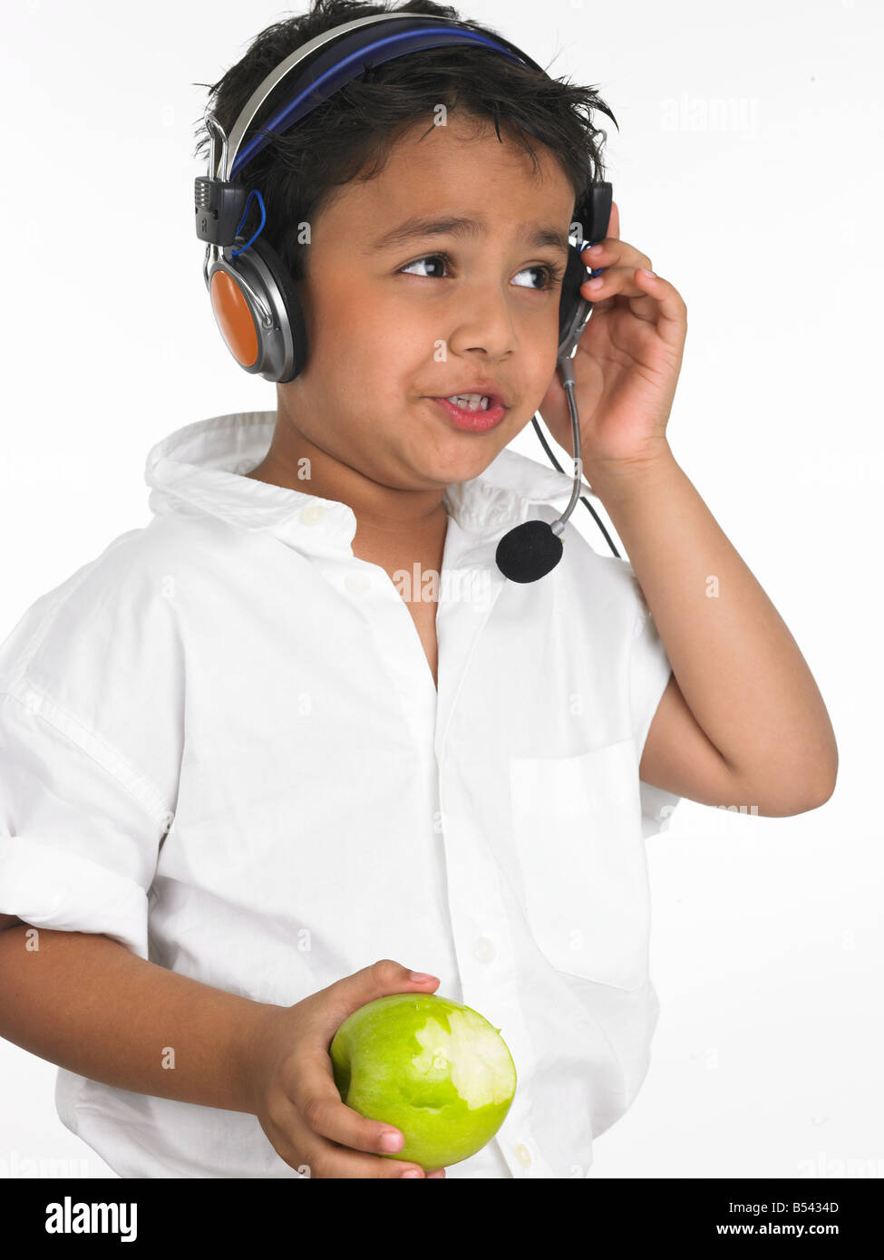 Asian boy eating a green apple Stock Photo - Alamy