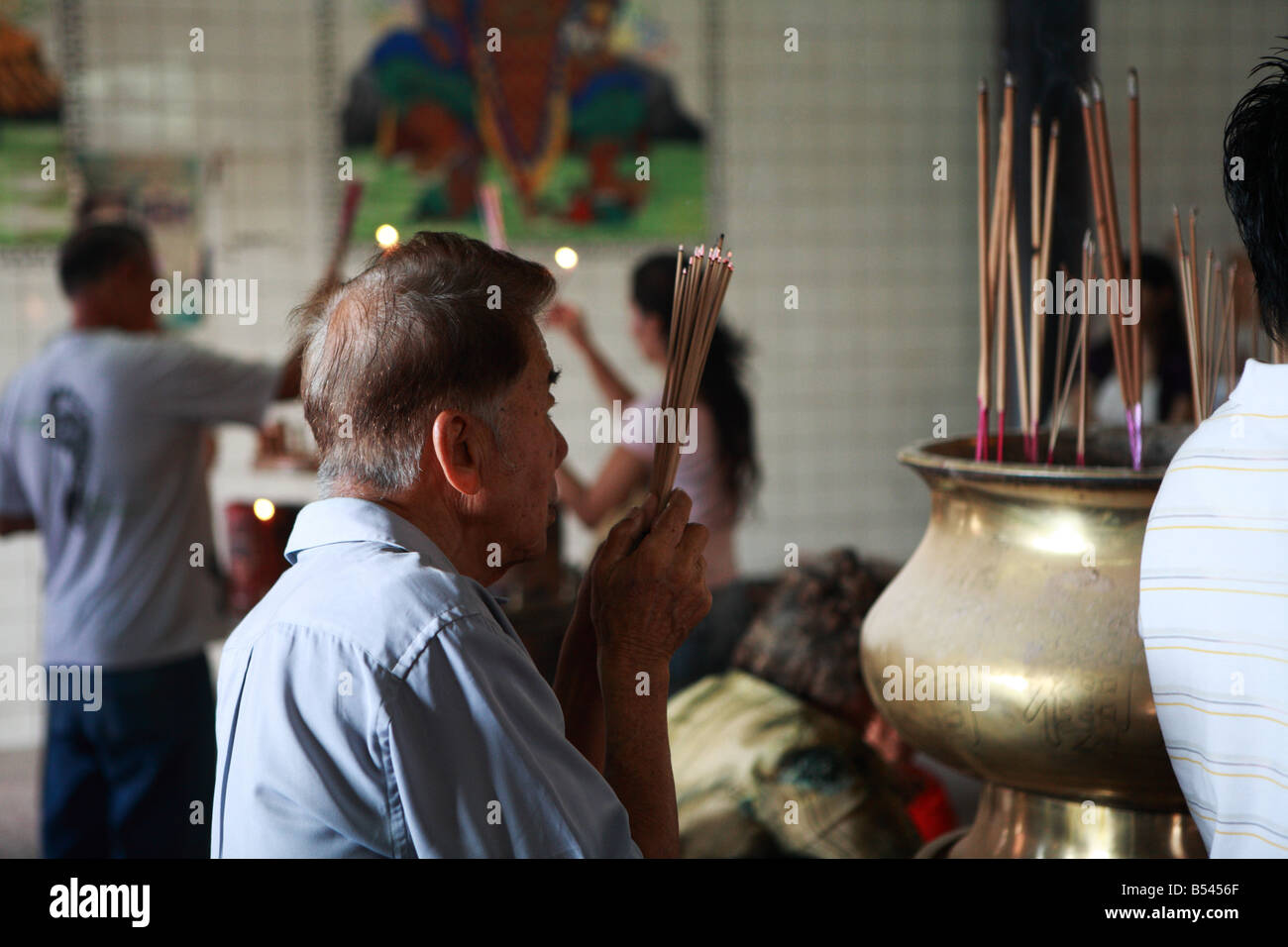 Man praying in temple, Penang, Malaysia Stock Photo - Alamy