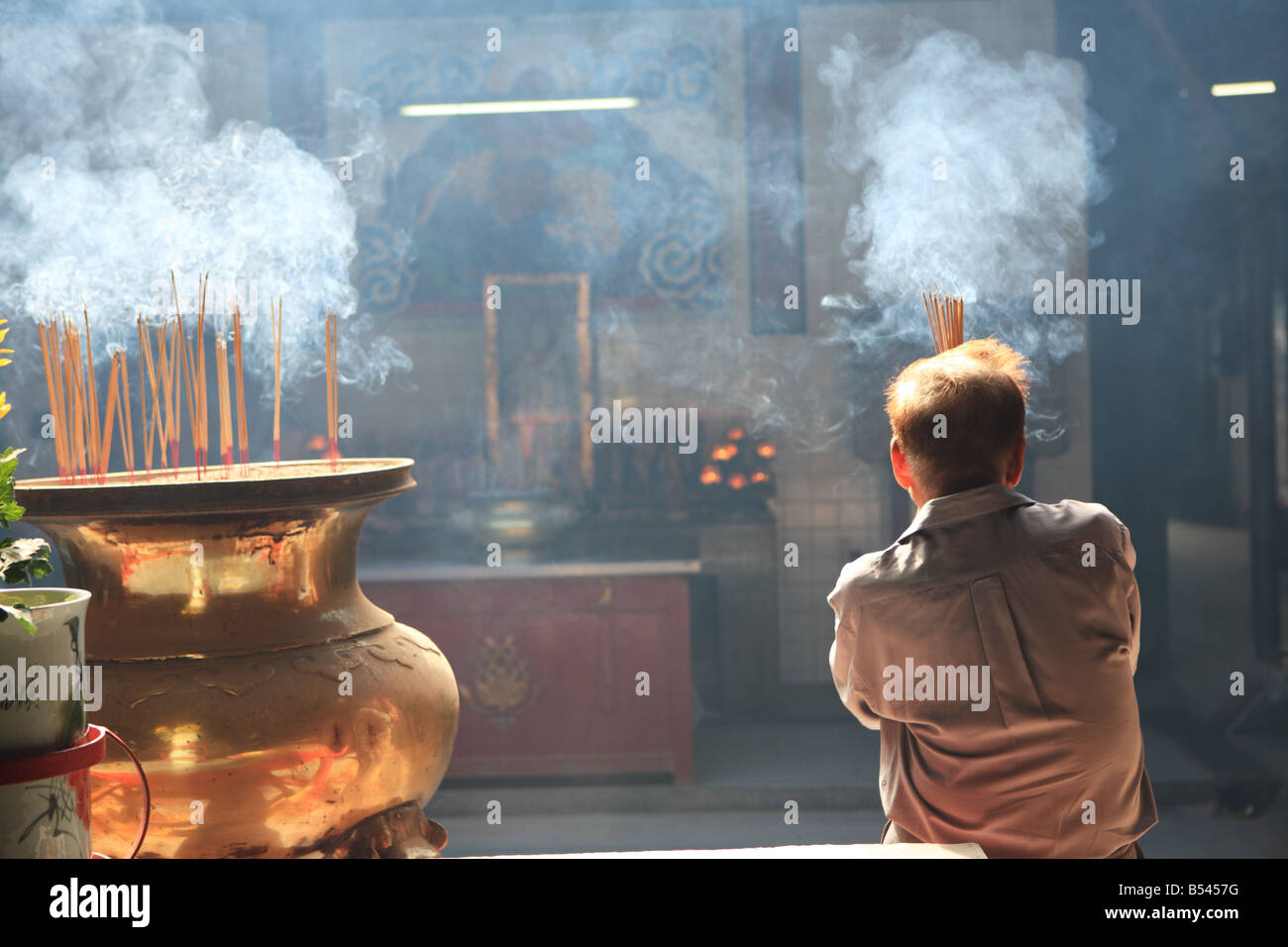 Man praying in temple, Penang, Malaysia Stock Photo - Alamy