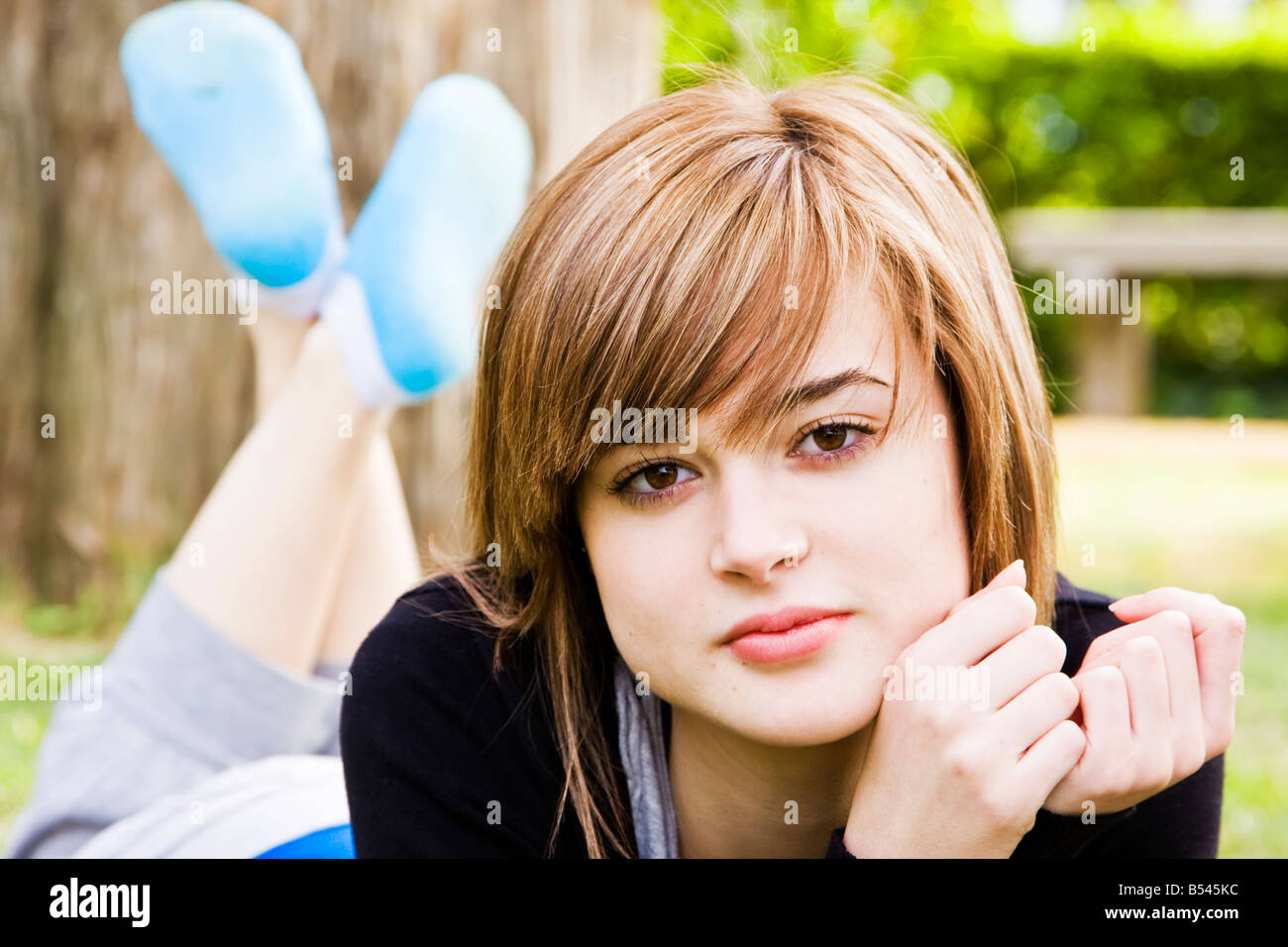 Beautiful young woman resting in the park Stock Photo - Alamy