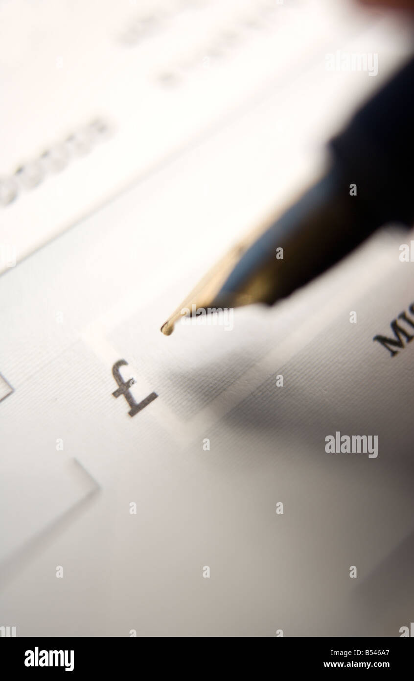 Close up of a pen and cheque. Writing a cheque Stock Photo - Alamy