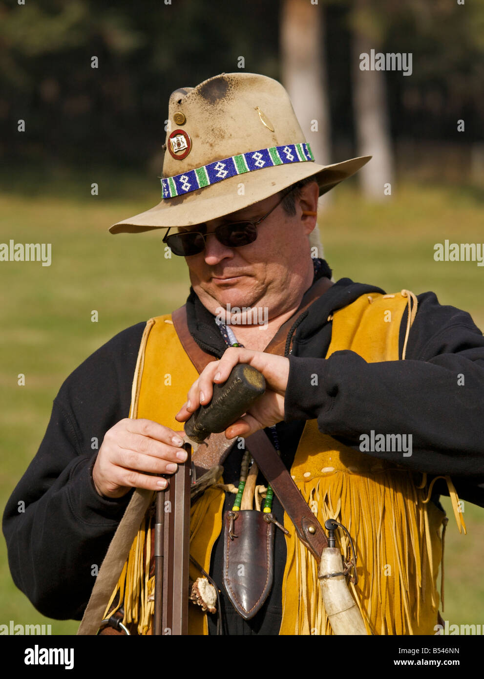 Man wearing trapper costume demonstrating black powder rifle at Steam ...