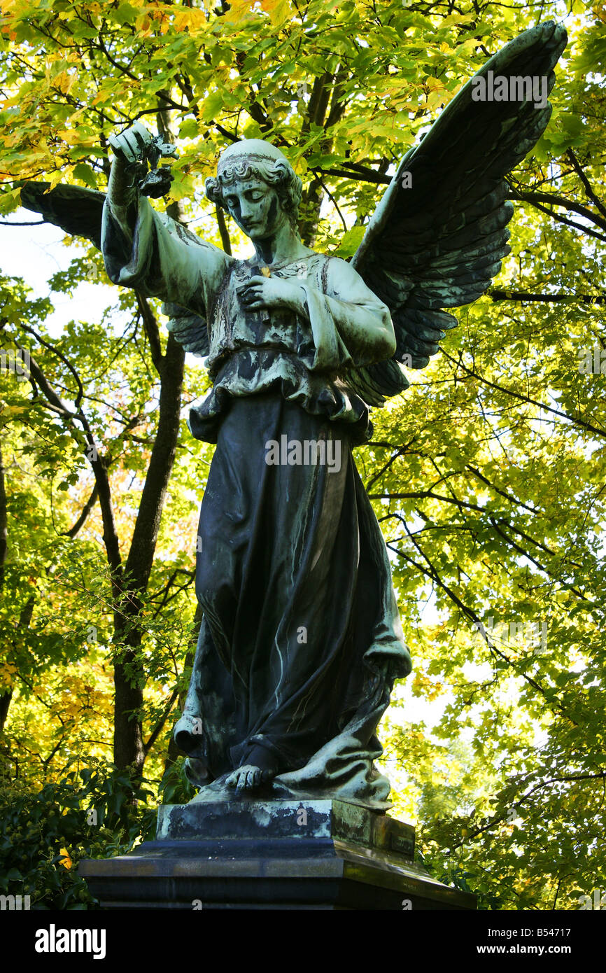 winged angel holding a flower Stock Photo - Alamy