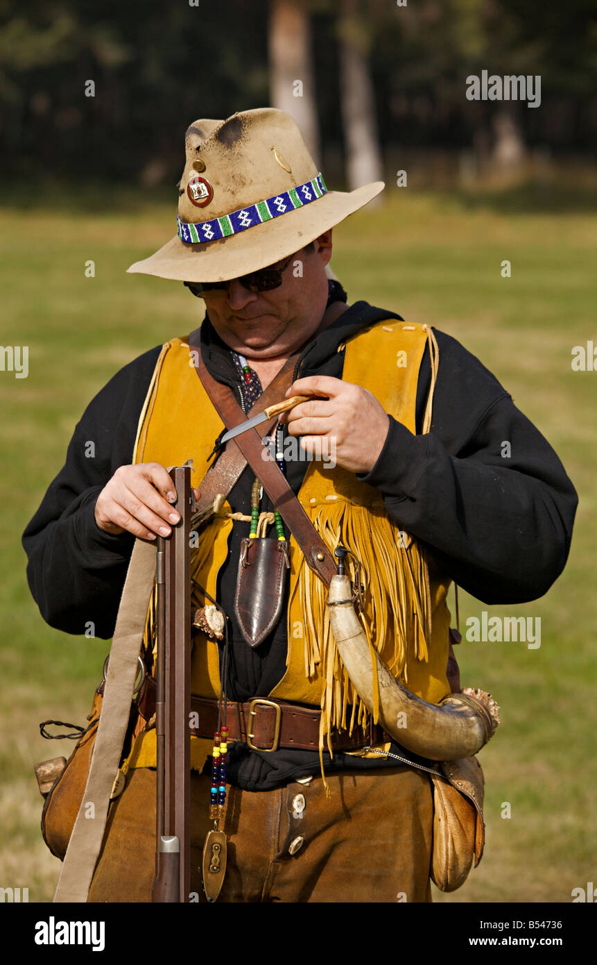Man wearing trapper costume demonstrating black powder rifle at Steam ...