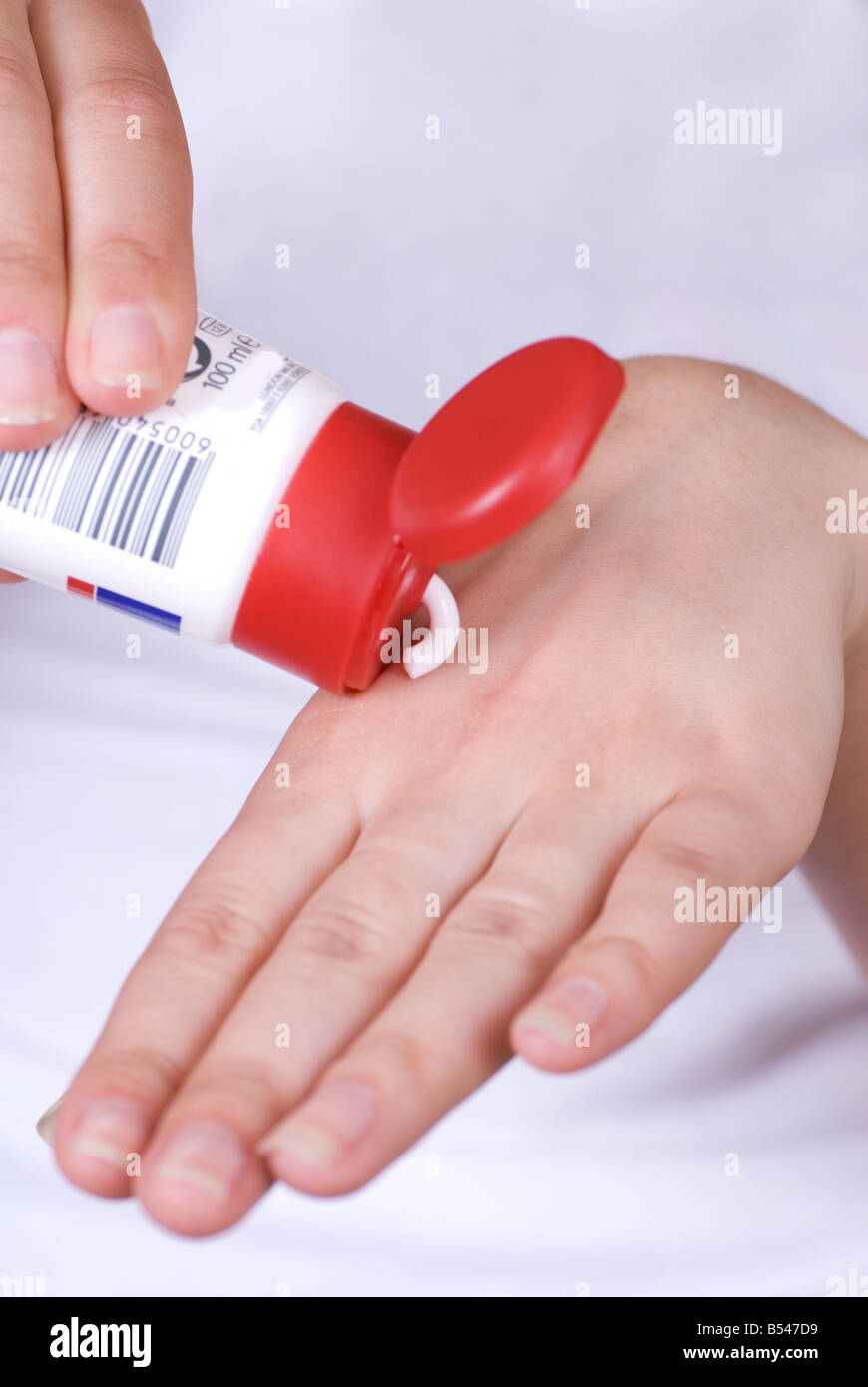 Woman applying hand cream Stock Photo - Alamy
