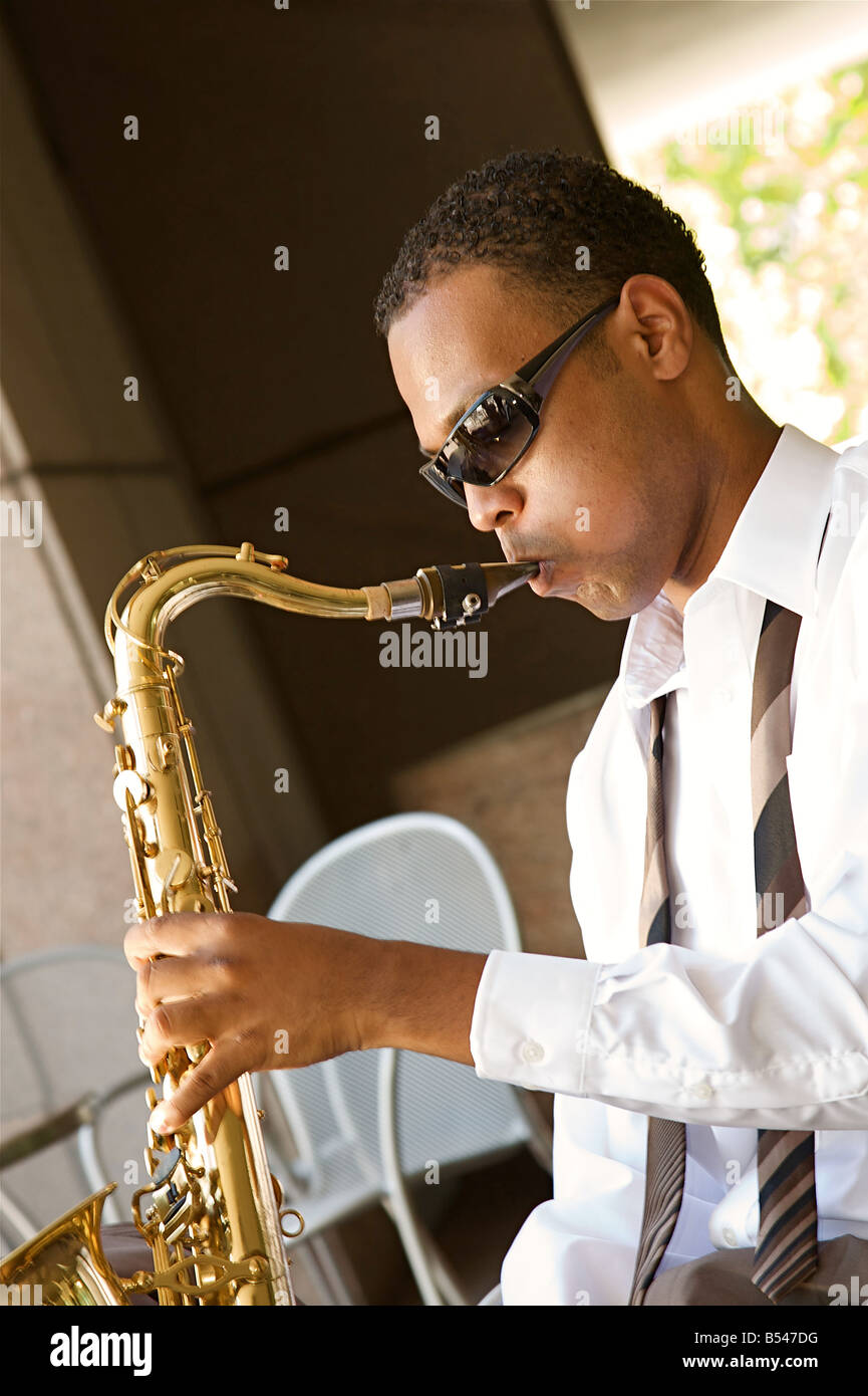 A young and trendy Black British saxophone musician Stock Photo - Alamy