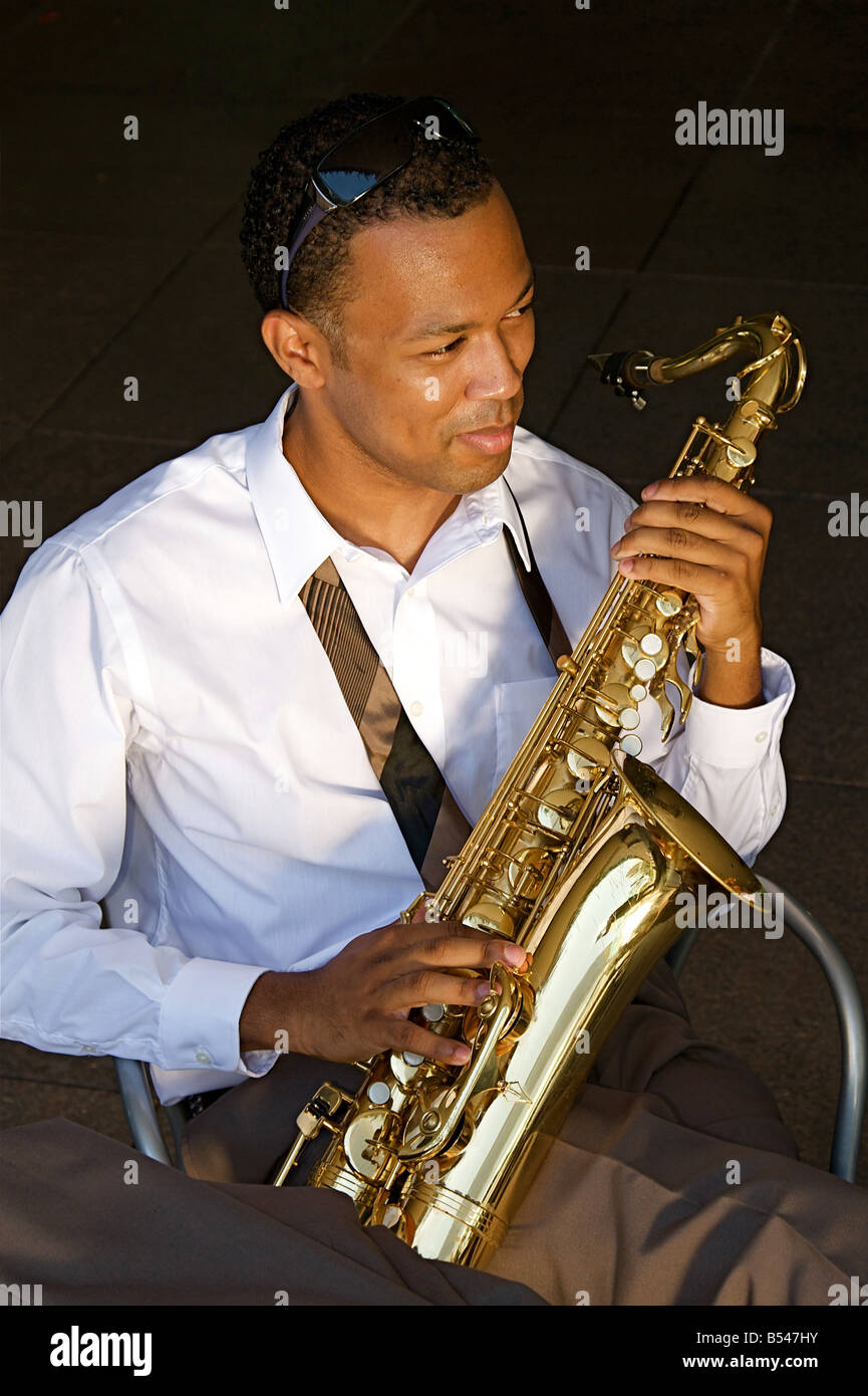 A young and trendy Black British saxophone musician Stock Photo - Alamy