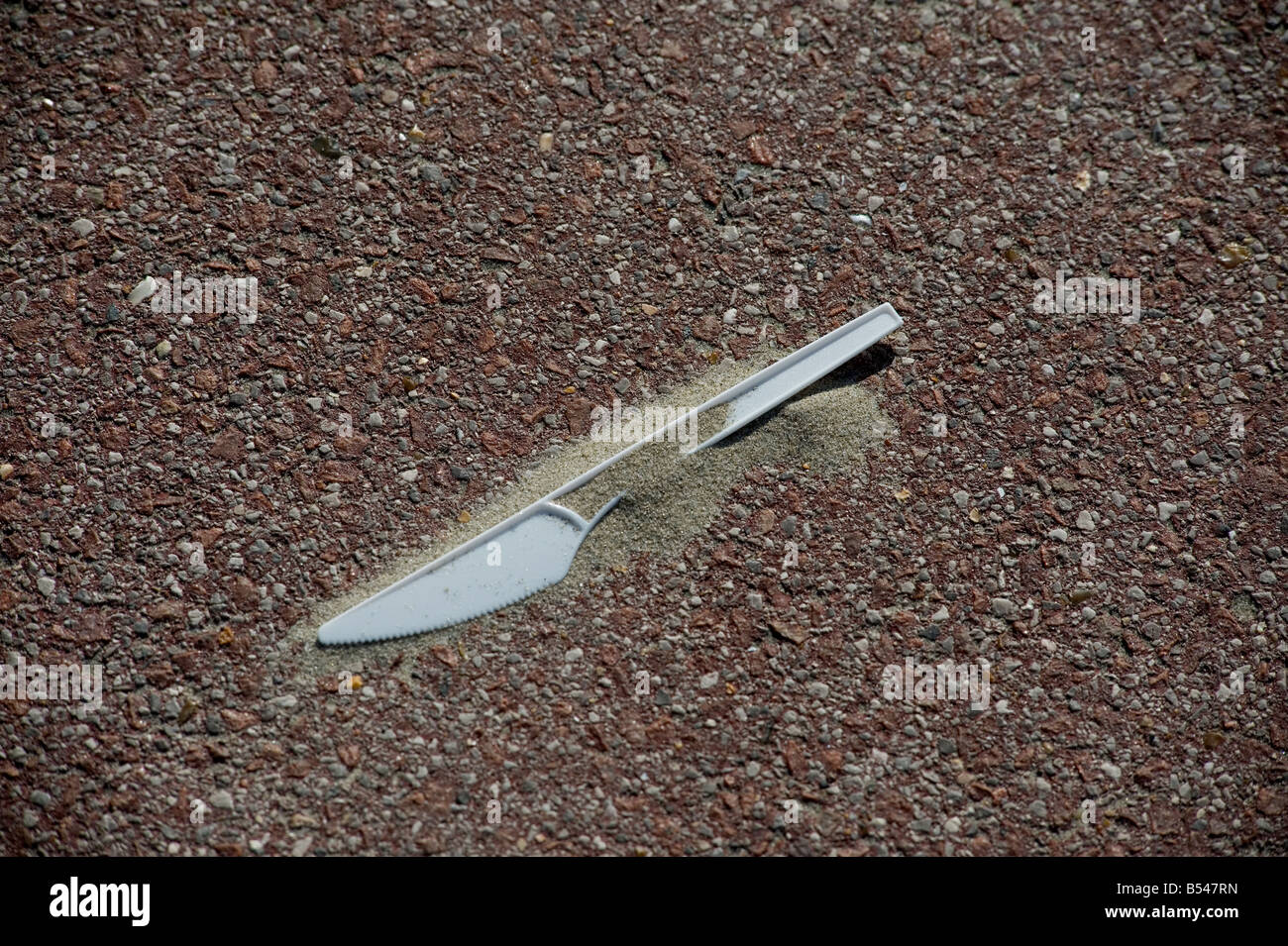 Plastic knife and sand 2008 Stock Photo - Alamy