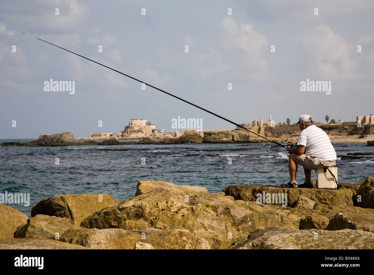Fisherman at Ancient Cesarea Harbor Stock Photo - Alamy