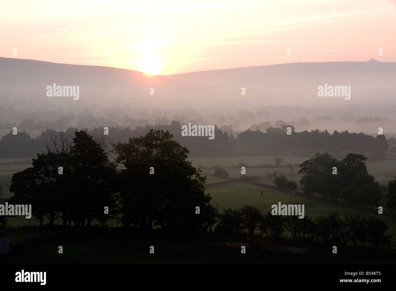 misty sunrise over the castleton valley with win hill in the distance ...