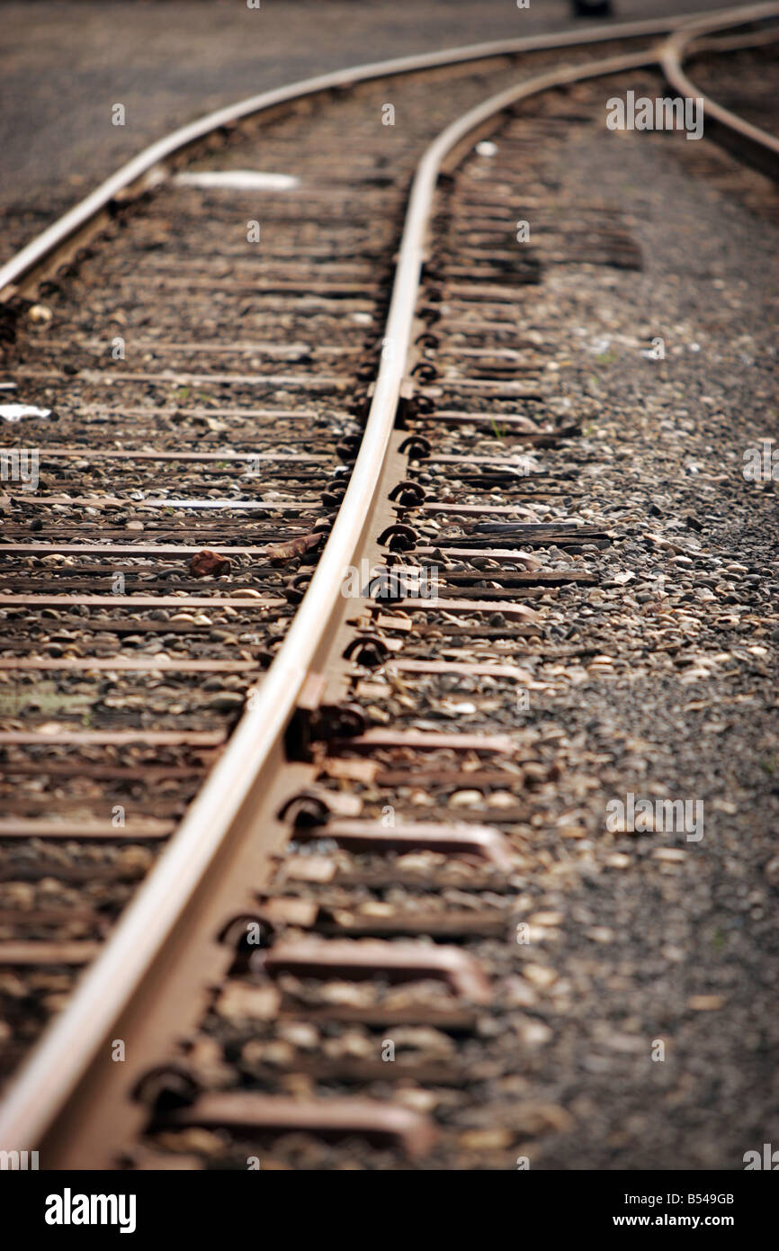 Rusty industrial train tracks intersecting in the distance Stock Photo ...