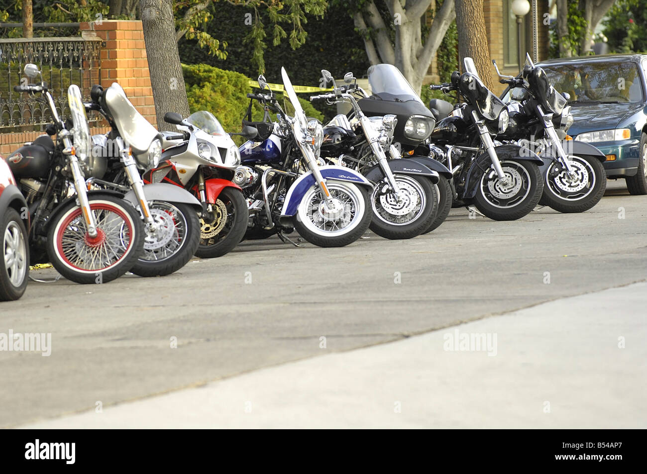 A row of motorcycles line a city street Stock Photo - Alamy