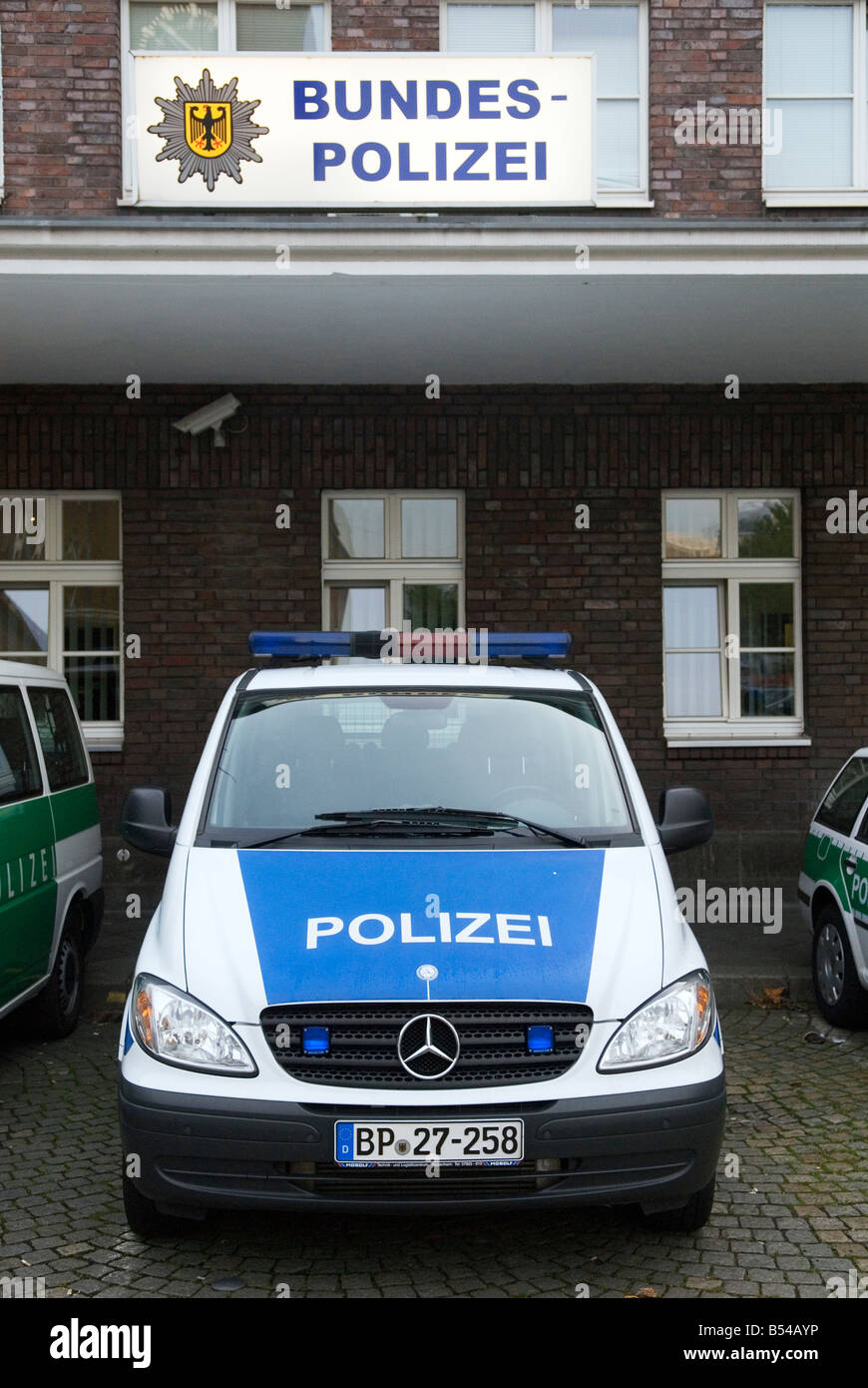 old style green and new style blue police cars are lined up in front of ...