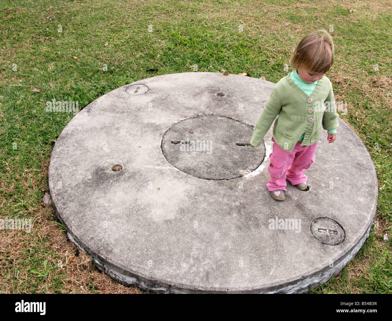 Child girl standing on a cement circle Stock Photo - Alamy