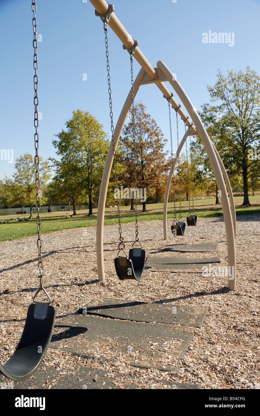 empty swing set on playground in fall Stock Photo - Alamy